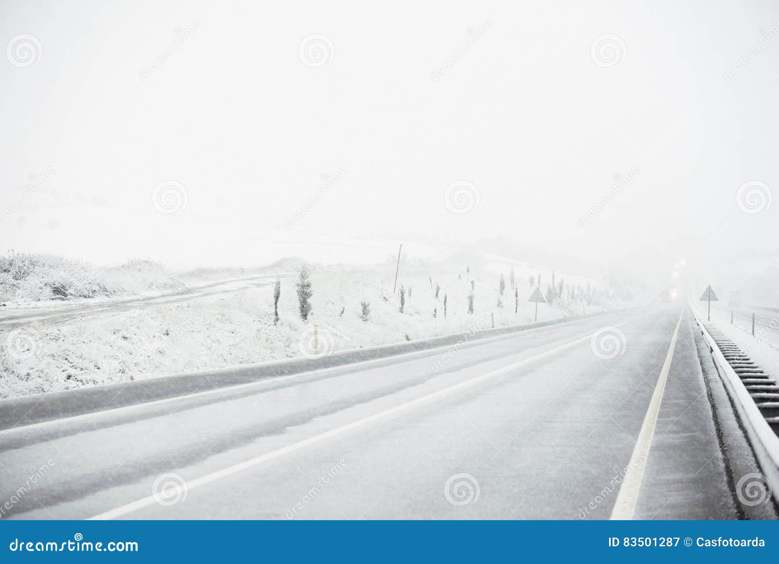 Road under blizzard stock image. Image of highway, sign - 83501287