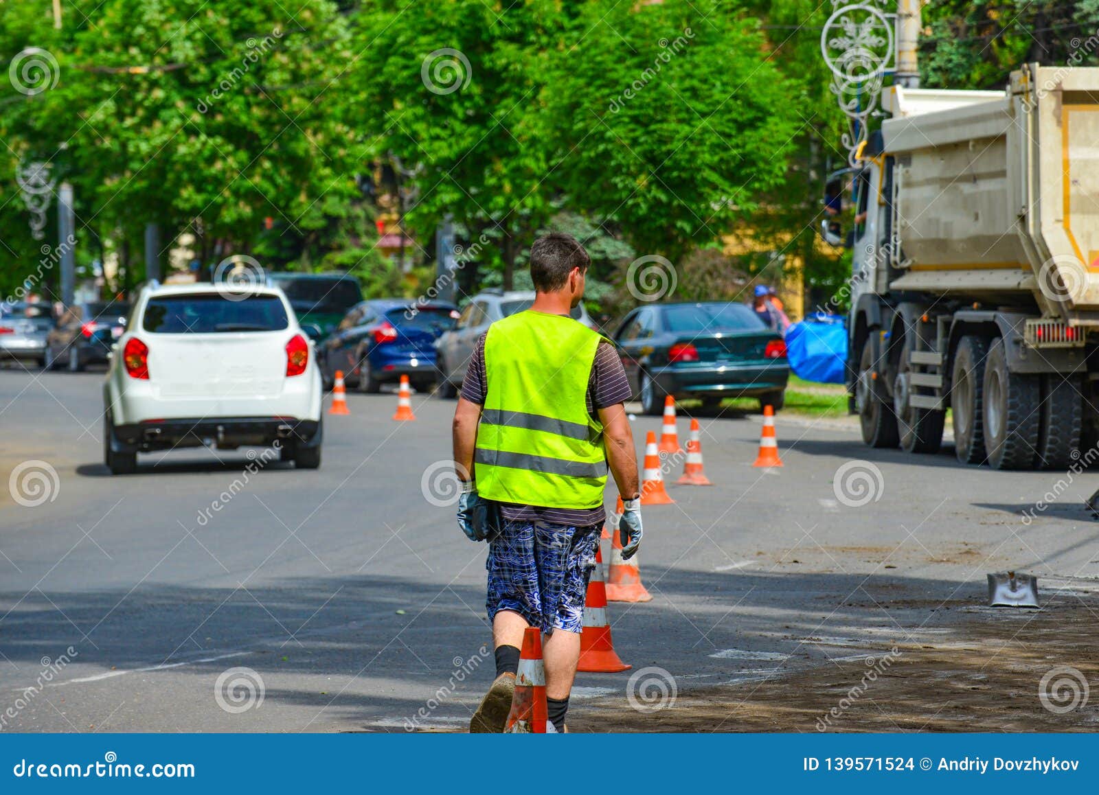 Road Worker in Protective Clothes on the Repair of the Road Editorial ...