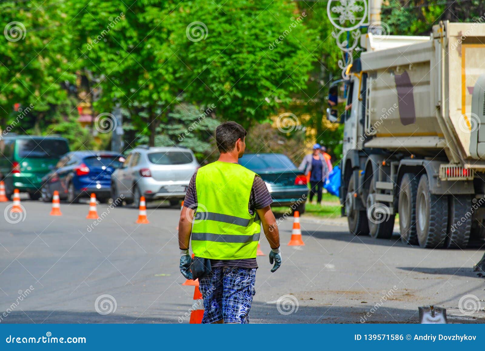 Road Worker in Protective Clothes on the Repair of the Road Editorial ...