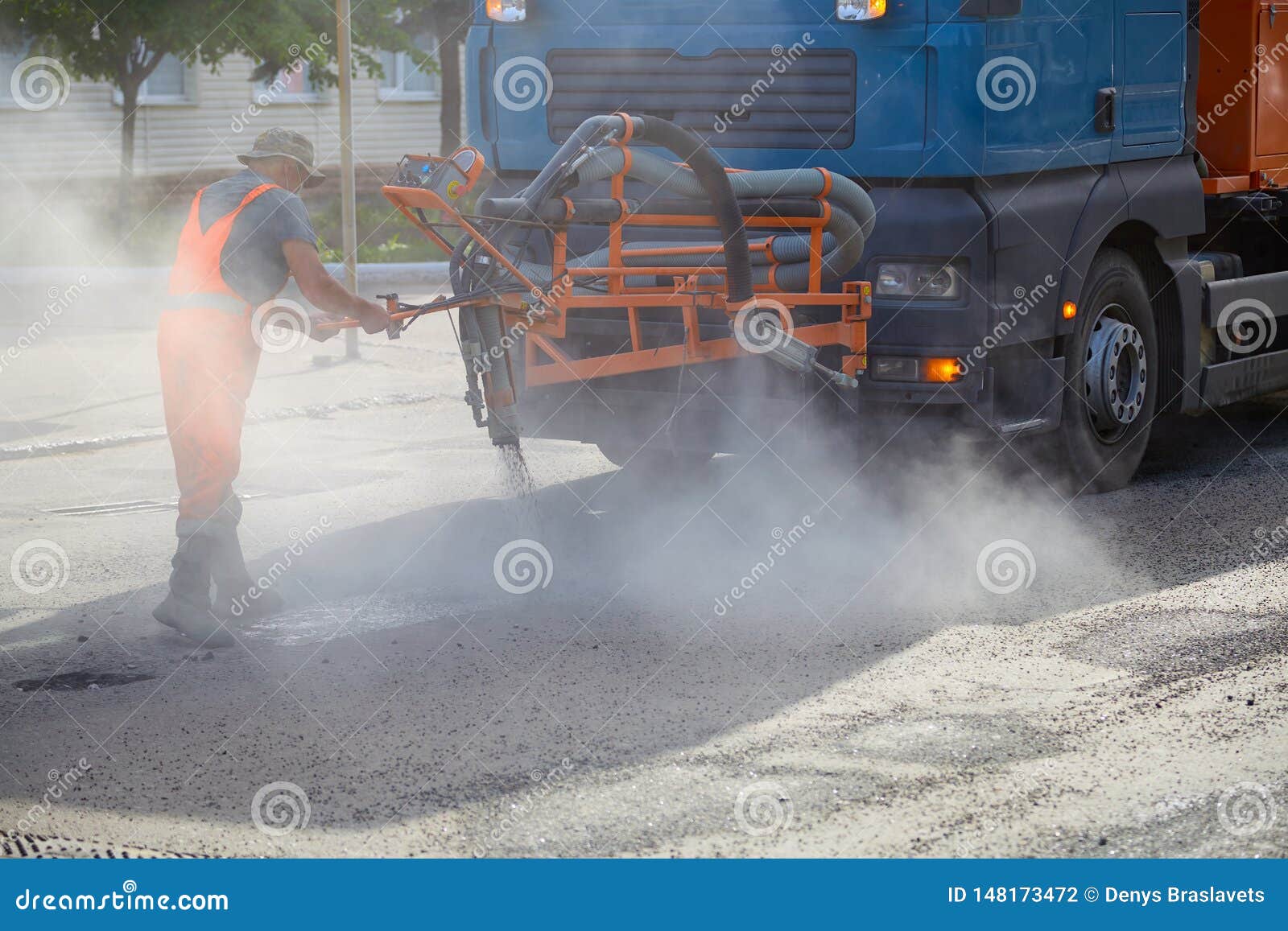 Road Worker Repairing Asphalt Coating, Using a Manipulator. Pitching ...