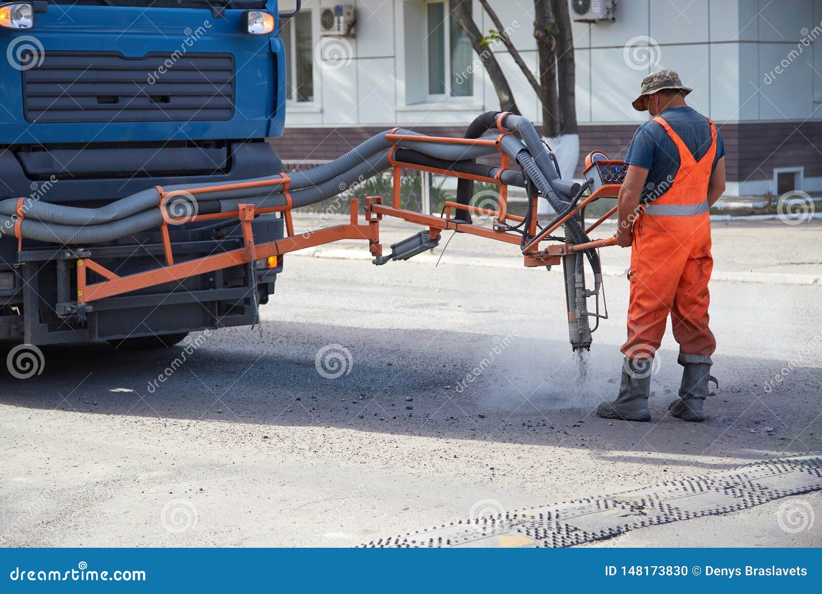 Road Worker Repairing Asphalt Coating, Using a Manipulator. Pitching ...