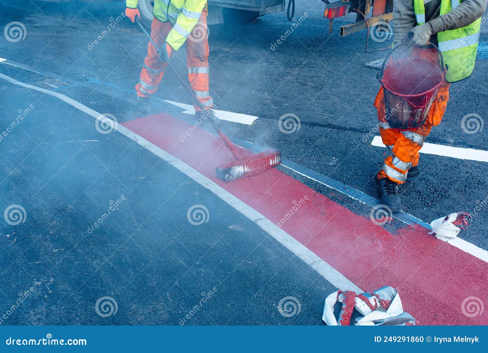 Road Workers Applying Hot Red Road Marking Paint on New Build Road ...