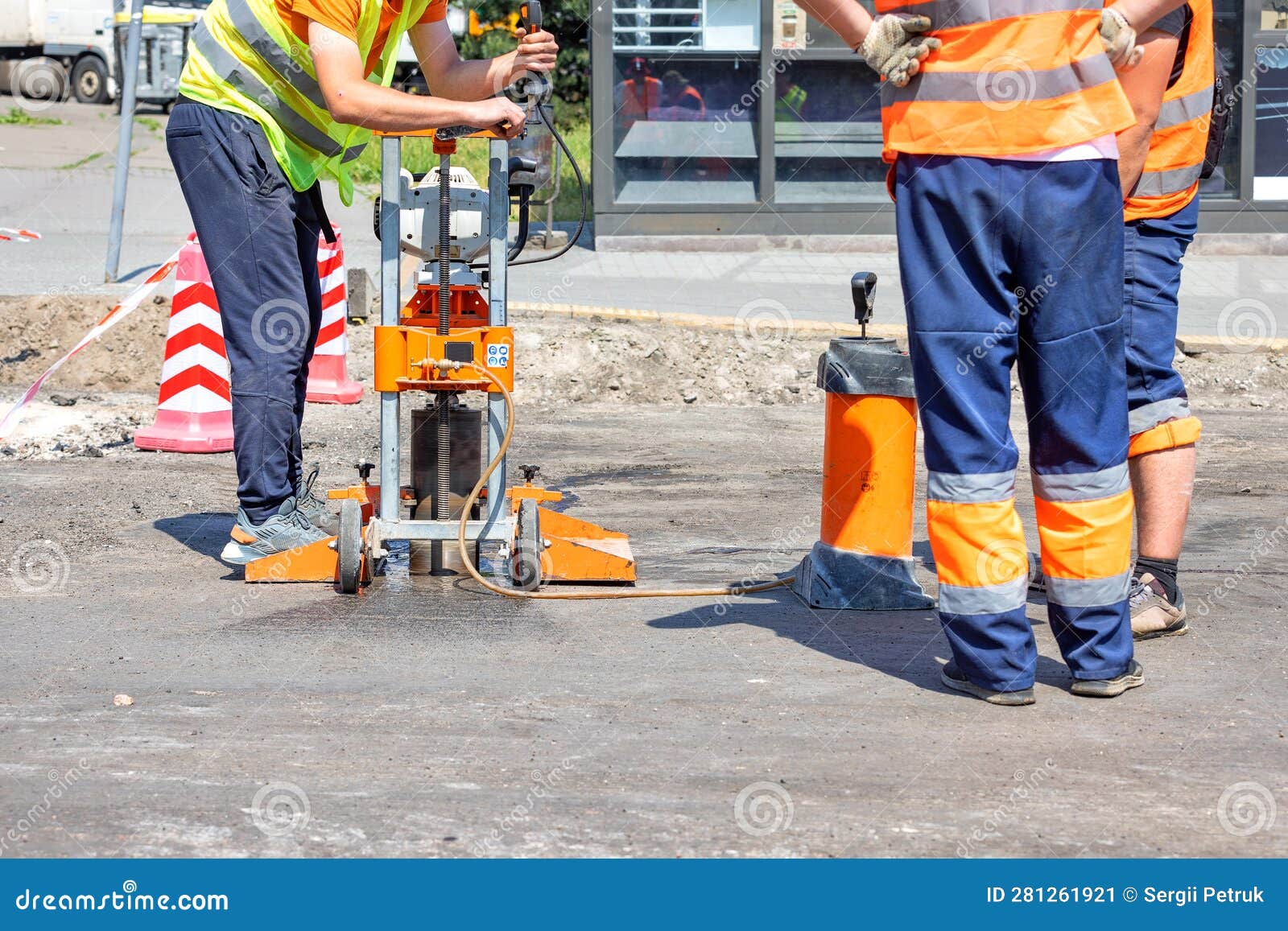 Road Workers Use a Core Drilling Machine To Take Cores from an Asphalt ...