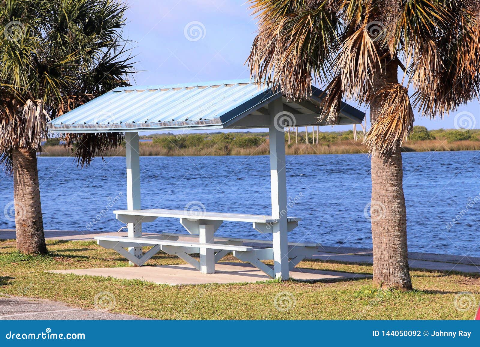 Roadside Covered Picnic Table beside a Blue Water Background Stock ...