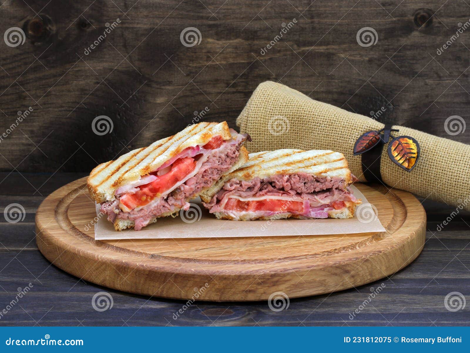 Roast Beef Panini with Tomato, Onion and Cheese on a Round Cutting ...