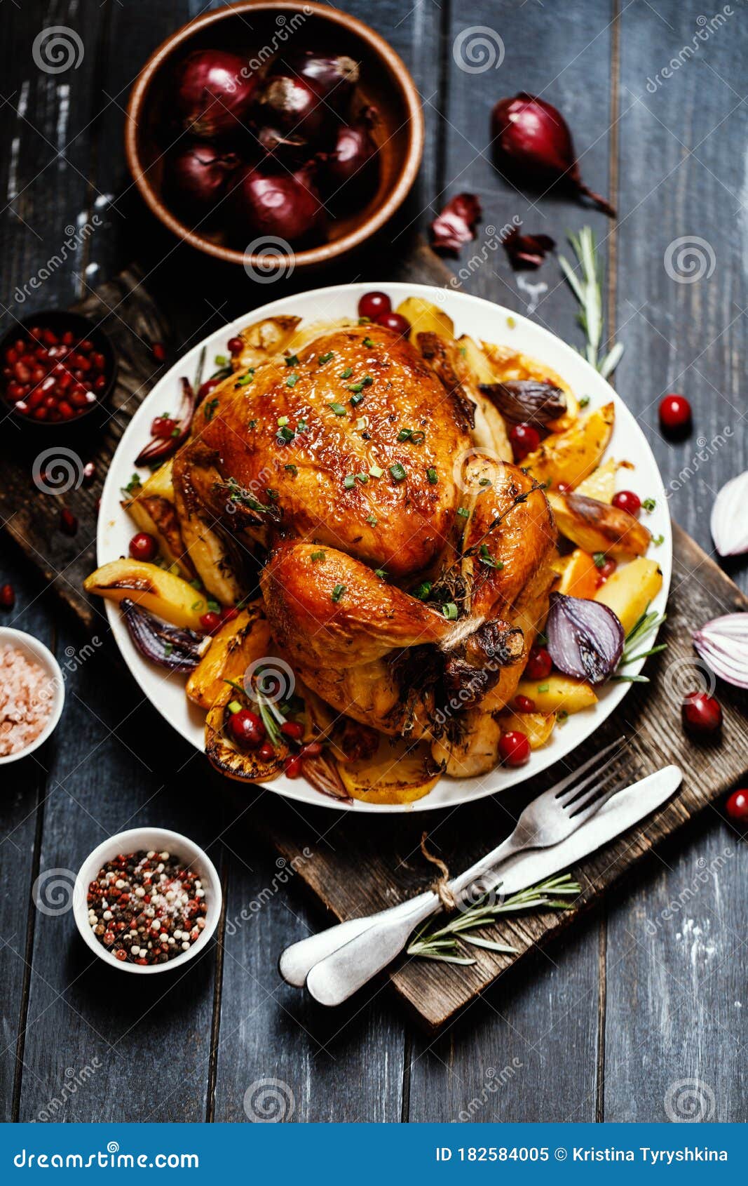 Roast Whole Chicken with Roast Vegetables on Plate on a Table Stock ...