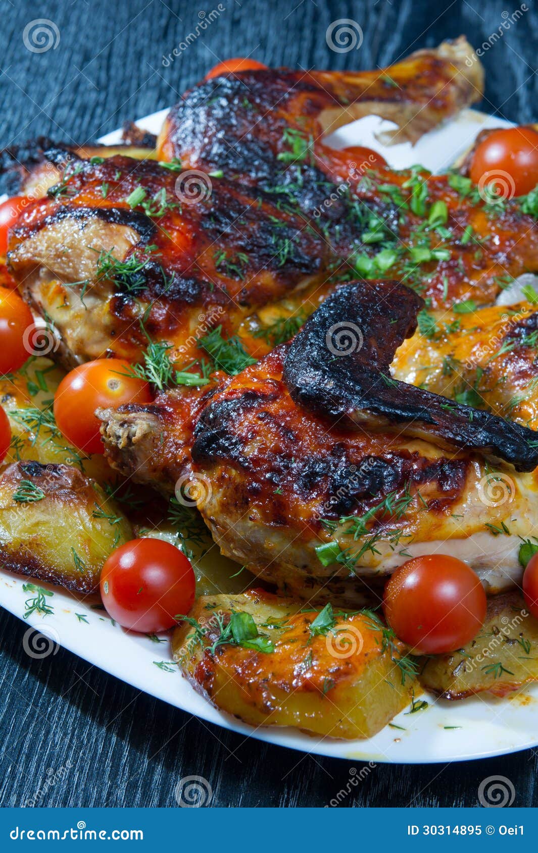 Roasted Chicken with Fried Potatoes and Cherry Tomatoes. Stock Image ...