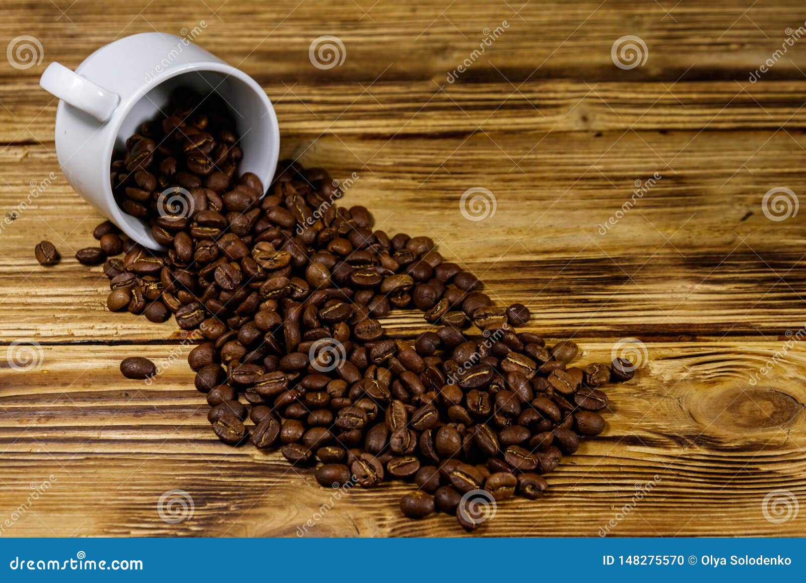 Roasted Coffee Beans Spill Out of Cup on Wooden Table Stock Photo ...
