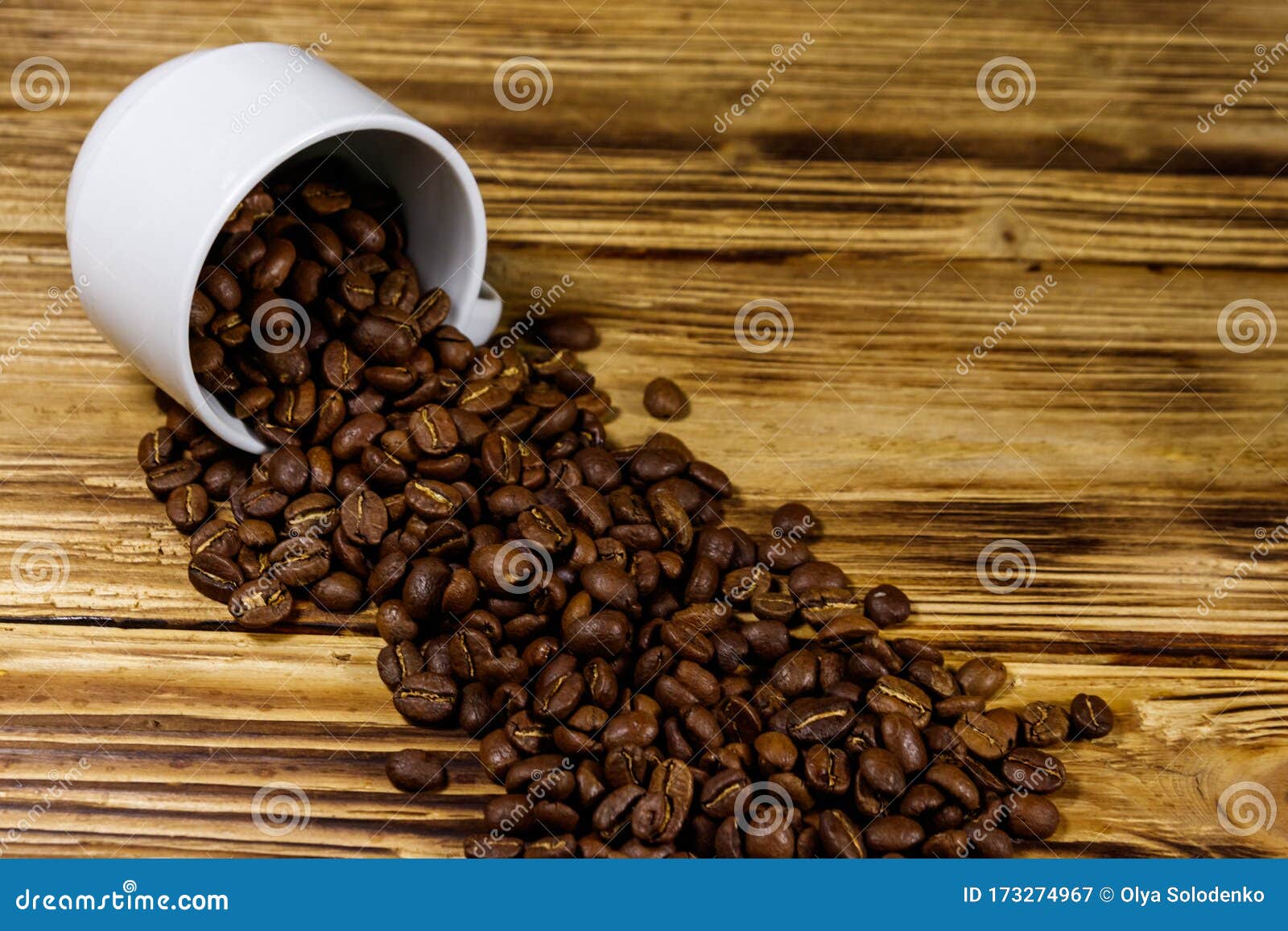 Roasted Coffee Beans Spill Out of Cup on Wooden Table Stock Image ...