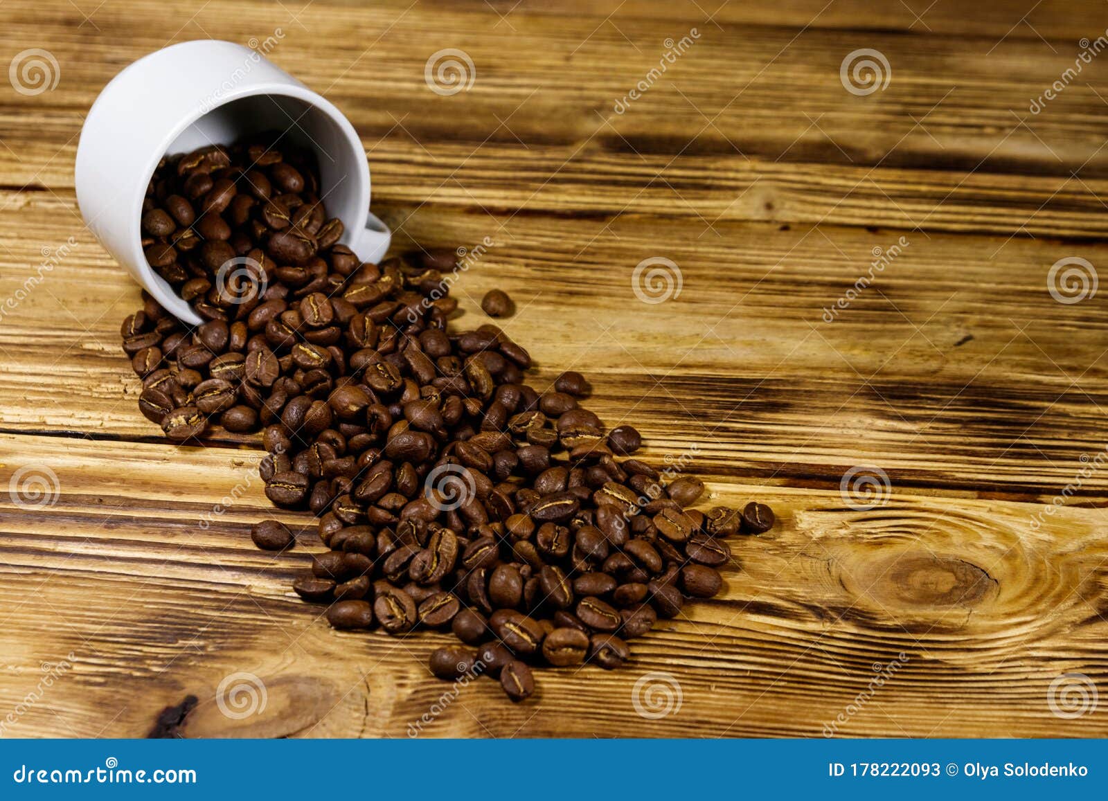 Roasted Coffee Beans Spill Out of Cup on Wooden Table Stock Image ...