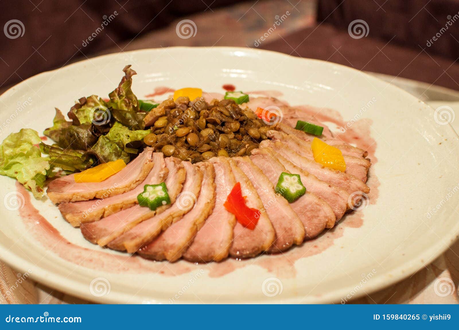 Roasted Duck with Beans and Vegetables Served on a Plate Stock Image ...