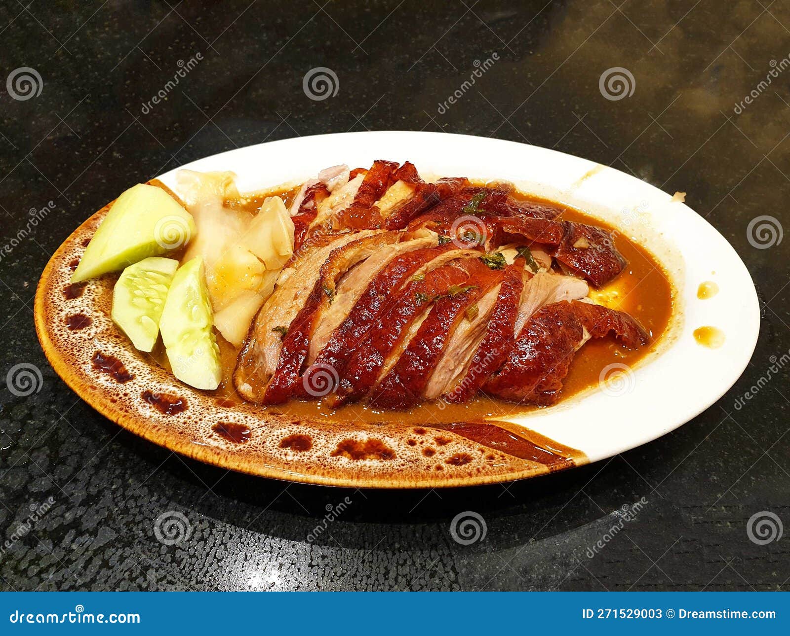 The Roasted Duck with Sliced Cucumber and Pickled Ginger on a Plate ...