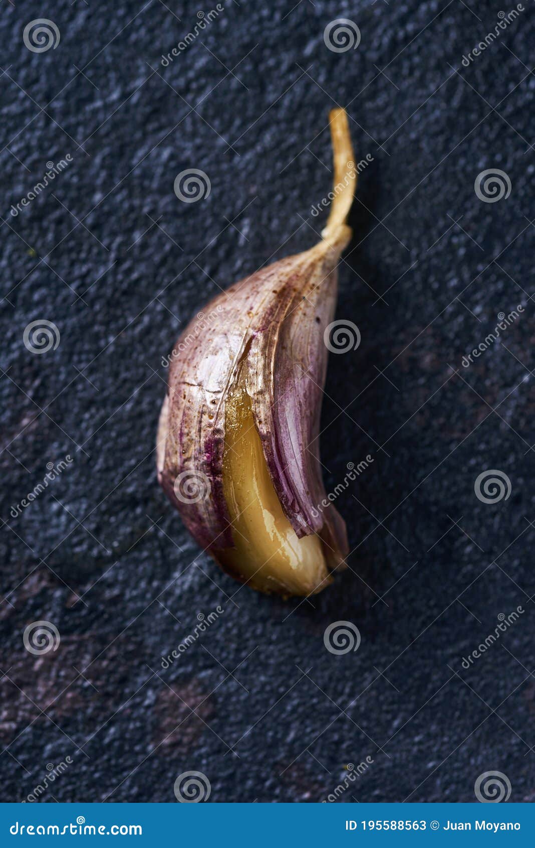Roasted Garlic on a Black Stone Surface Stock Image - Image of ...