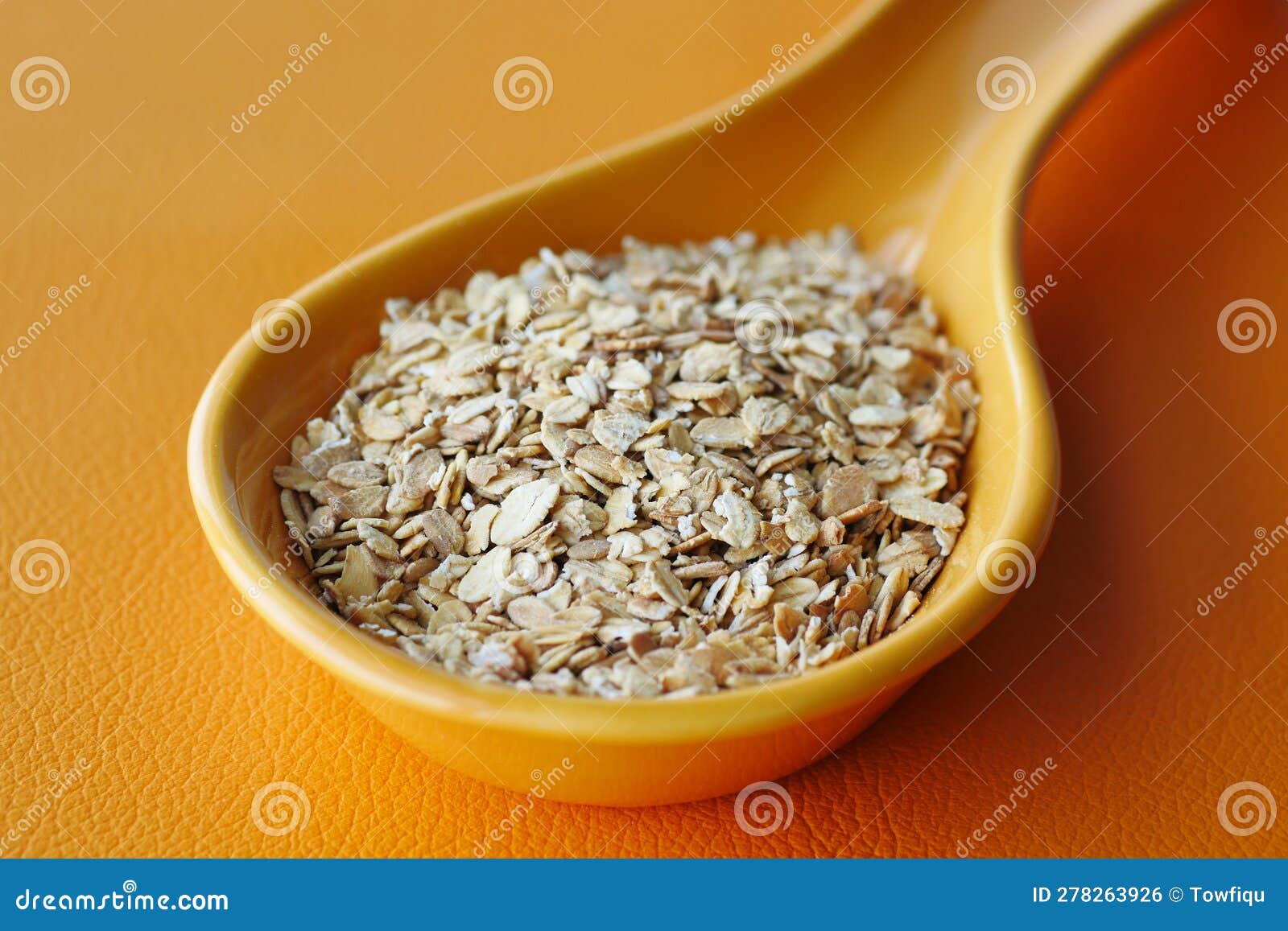 Roasted Oats Flakes in a Spoon on Orange Color Background Stock Photo ...