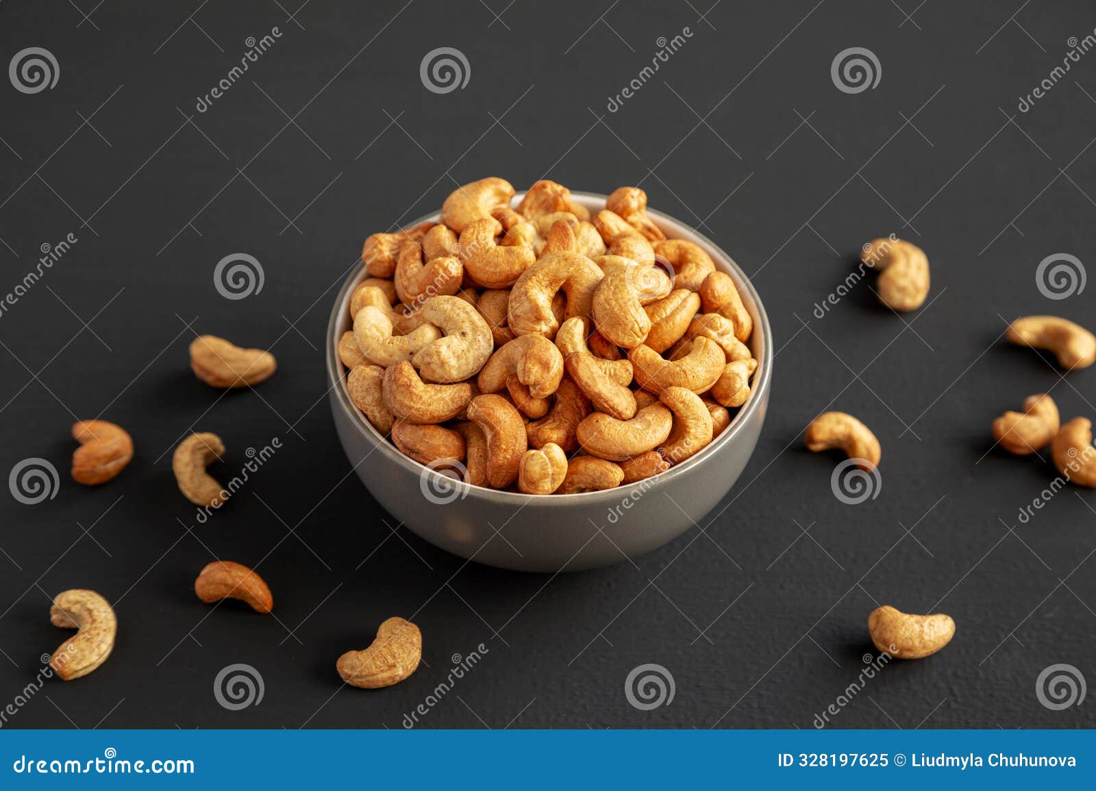 Roasted Organic Cashews in a Bowl on a Black Background, Side View ...