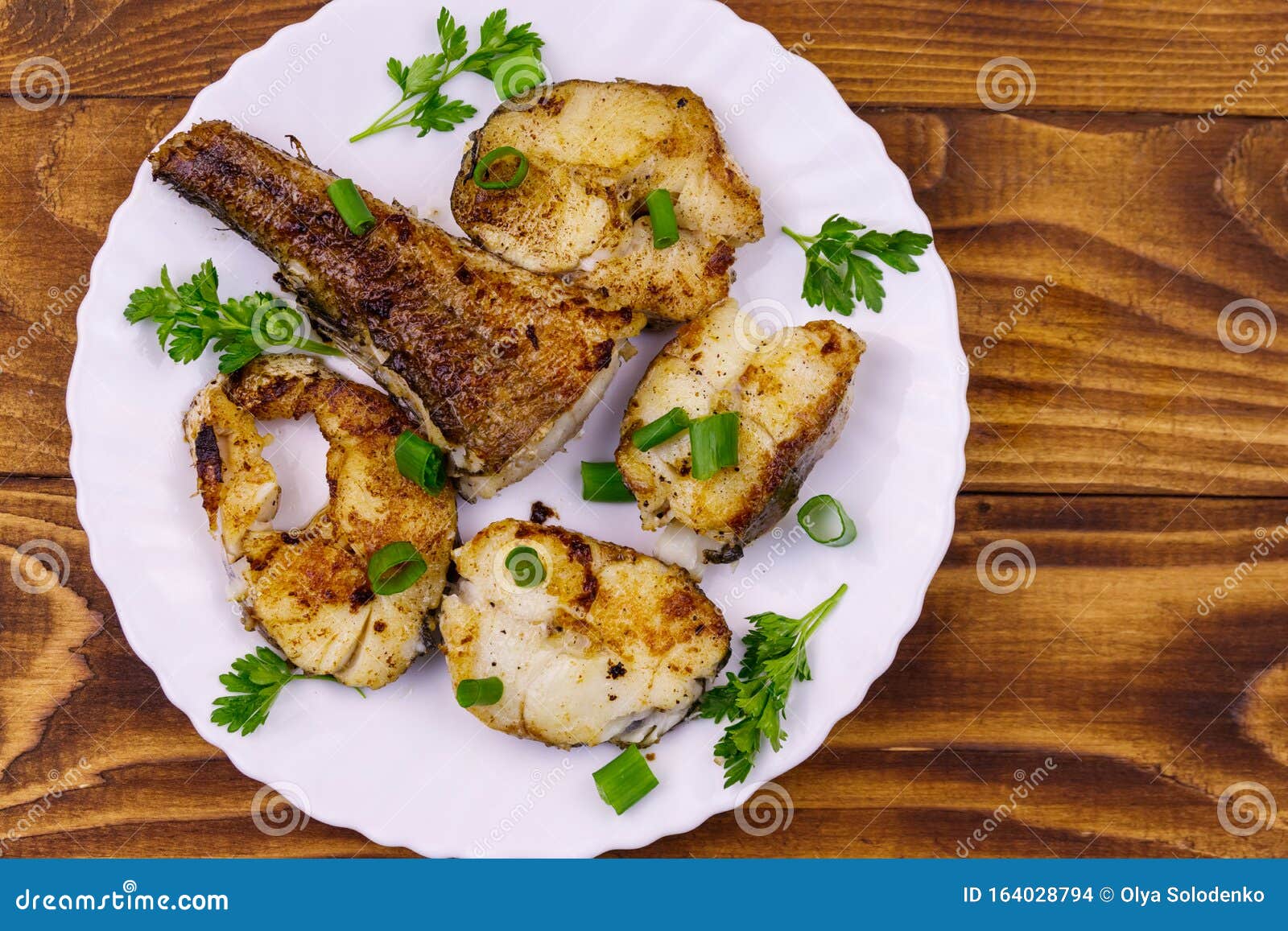 Roasted Pollock in White Plate on Wooden Table Stock Photo - Image of ...