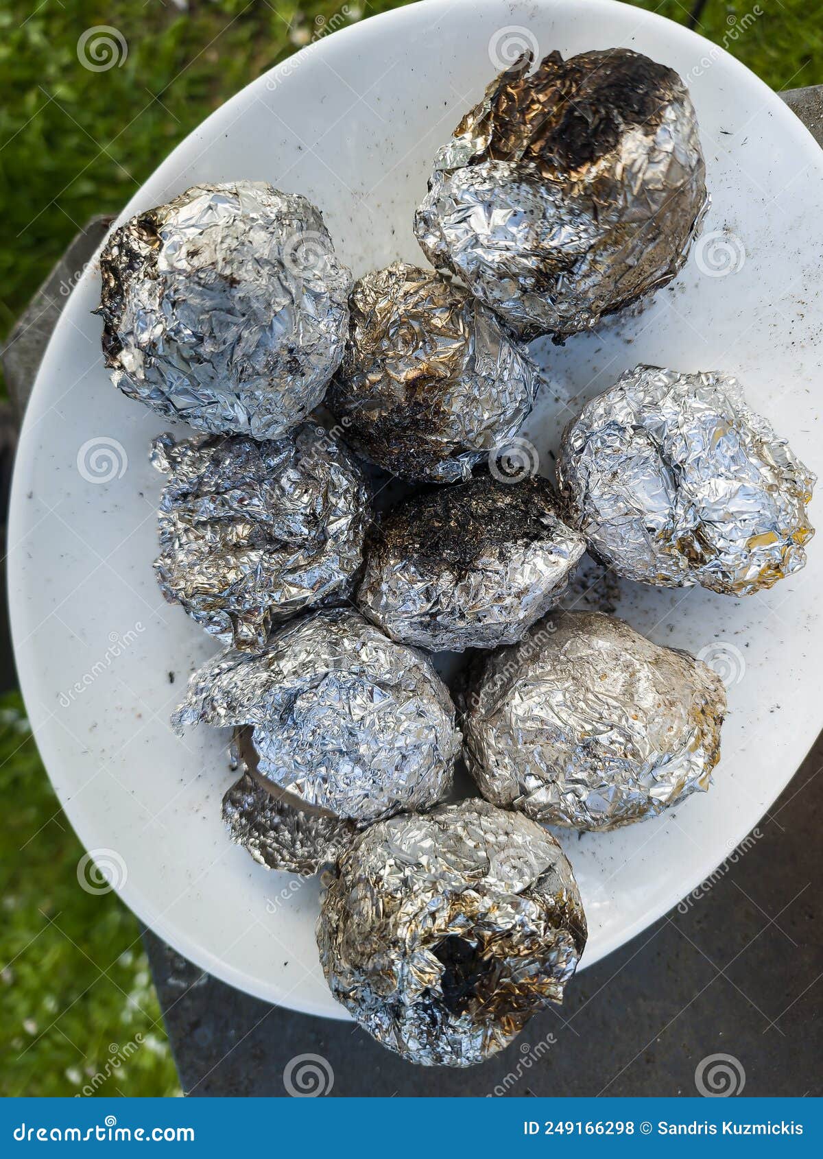 Roasted Potatoes Wrapped in Foil. Bake on the Fire Stock Photo - Image ...