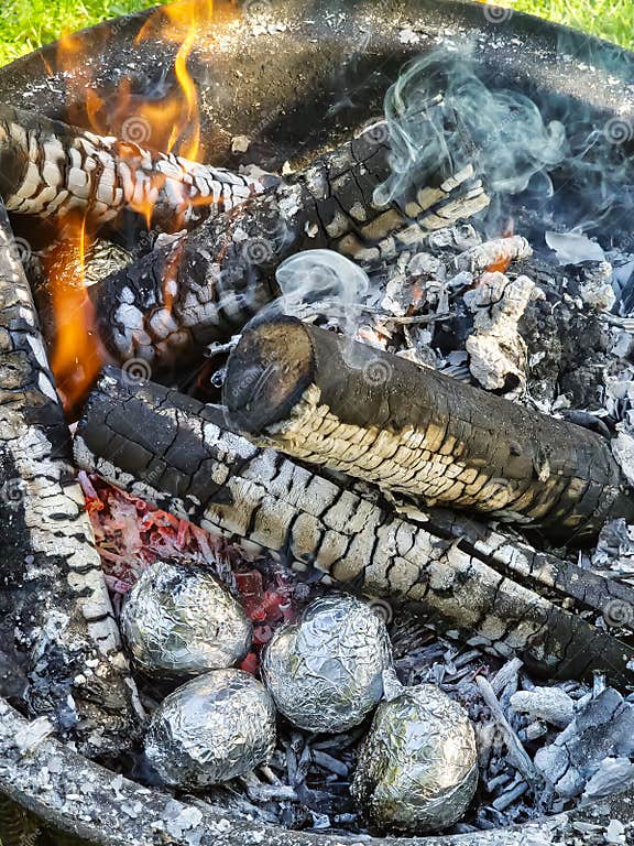 Roasted Potatoes Wrapped in Foil. Bake on the Fire Stock Photo - Image ...