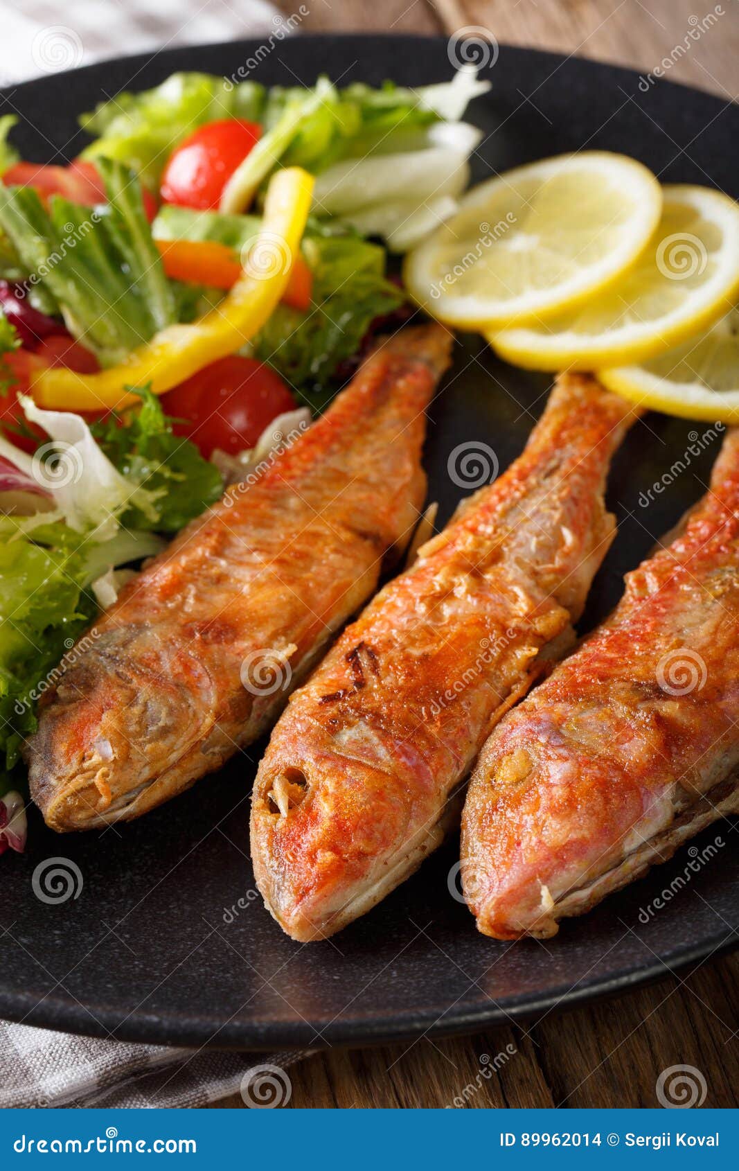 Roasted Red Mullet with Fresh Vegetables and Lemon Close-up. Vertical ...