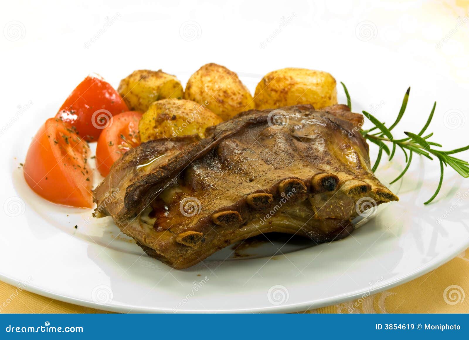 A Roasted Suckling Pig with Potatoes and Salad Stock Image - Image of ...