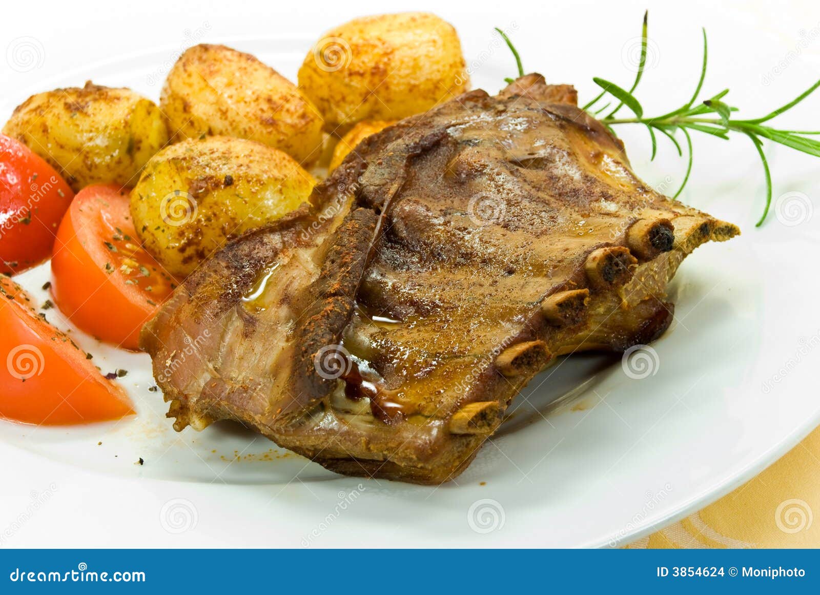 A Roasted Suckling Pig with Potatoes and Salad Stock Photo - Image of ...