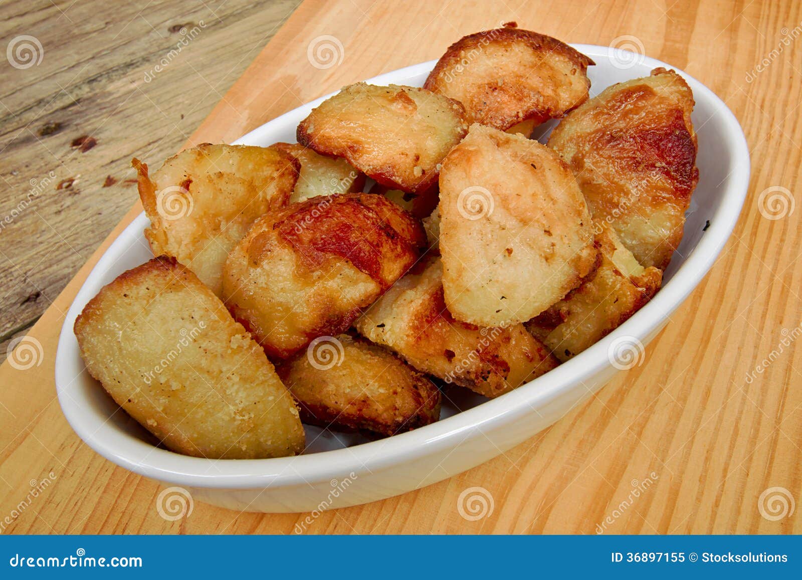Roasties in a serving dish stock image. Image of portion - 36897155