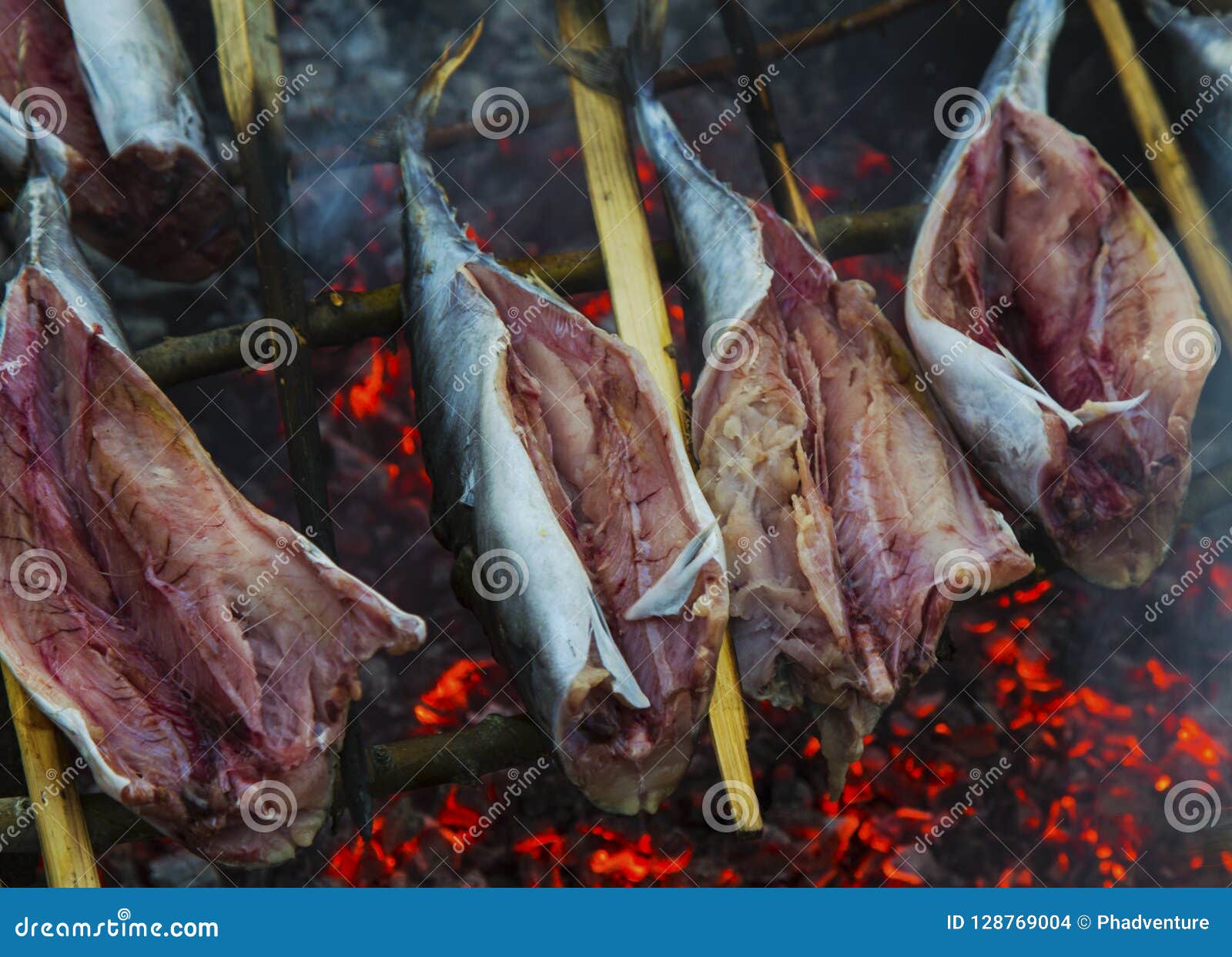 Roasting fish on fire stock photo. Image of cuisine - 128769004