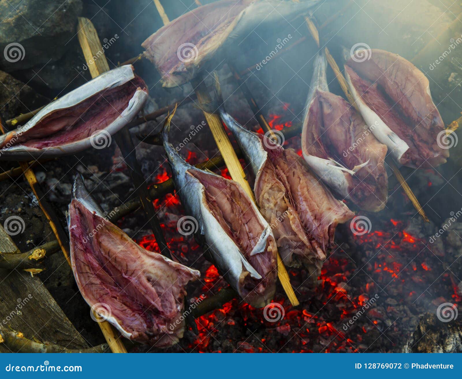 Roasting fish on fire stock photo. Image of cooking - 128769072