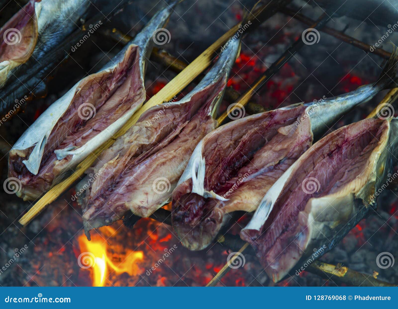 Roasting fish on fire stock photo. Image of gourmet - 128769068