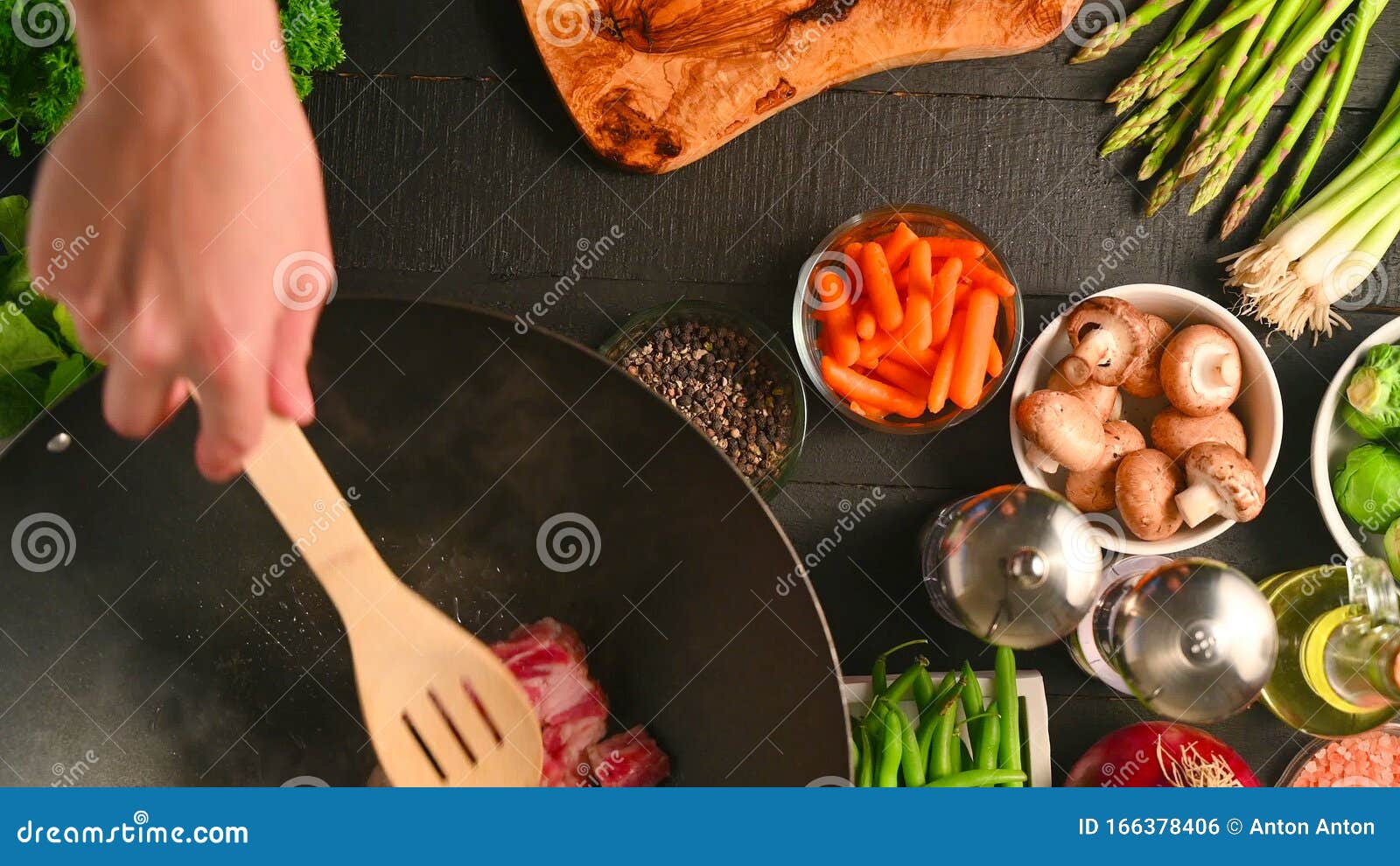 Roasting Fresh Meat in a Wok, on a Background with Vegetables Stock ...