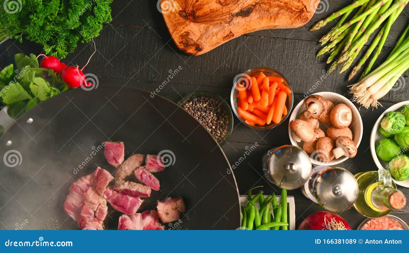 Roasting Fresh Meat in a Wok, on a Background with Vegetables Stock ...