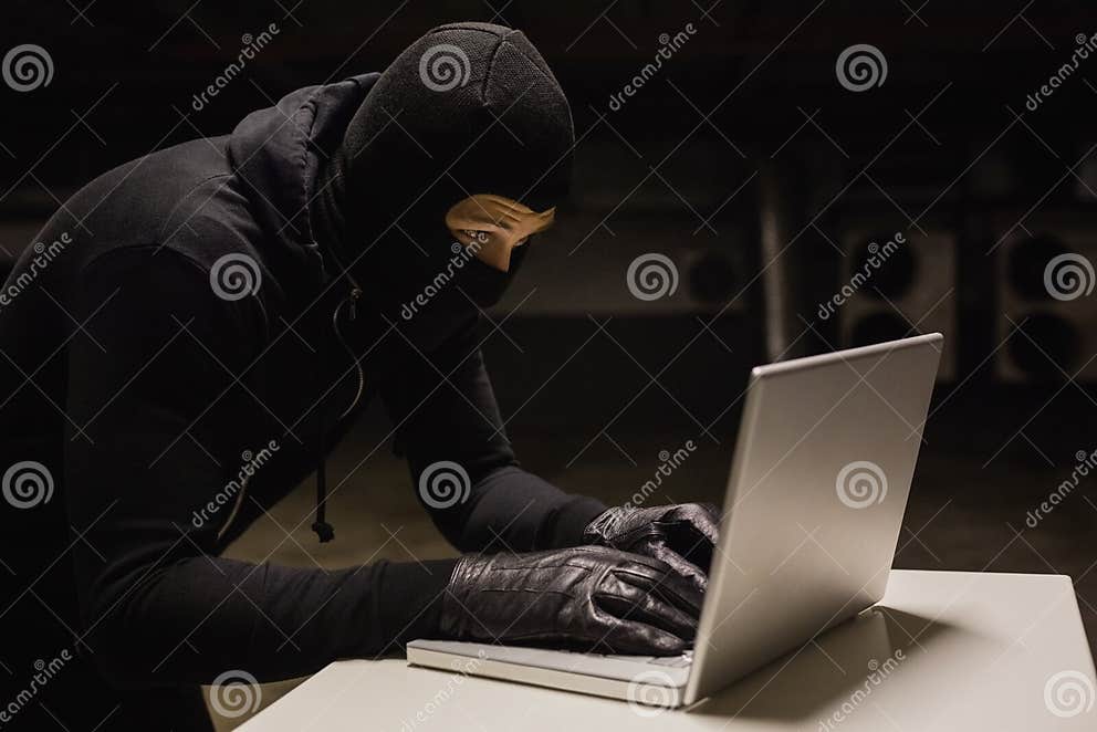 Robber at Desk Hacking a Laptop Stock Photo - Image of caucasian ...