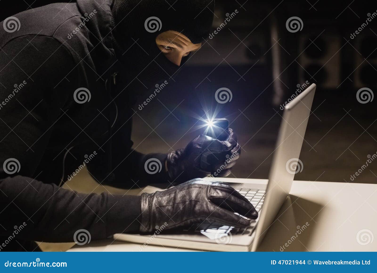 Robber Hacking a Laptop while Making Light with His Phone Stock Photo ...