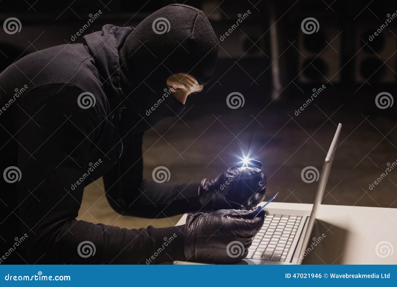 Robber Shopping Online while Making Light with His Phone Stock Photo ...
