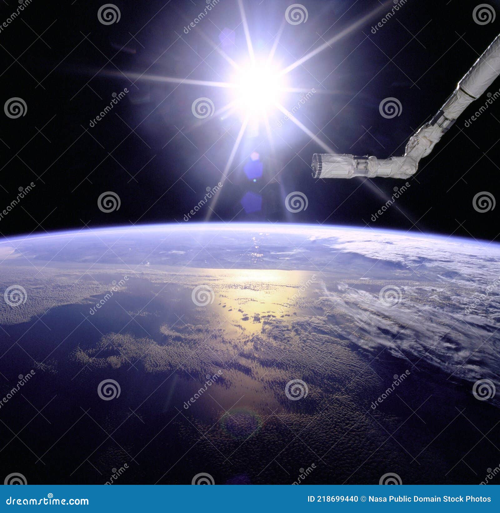 Robot Arm Over Earth With Sunburst Picture. Image: 218699440