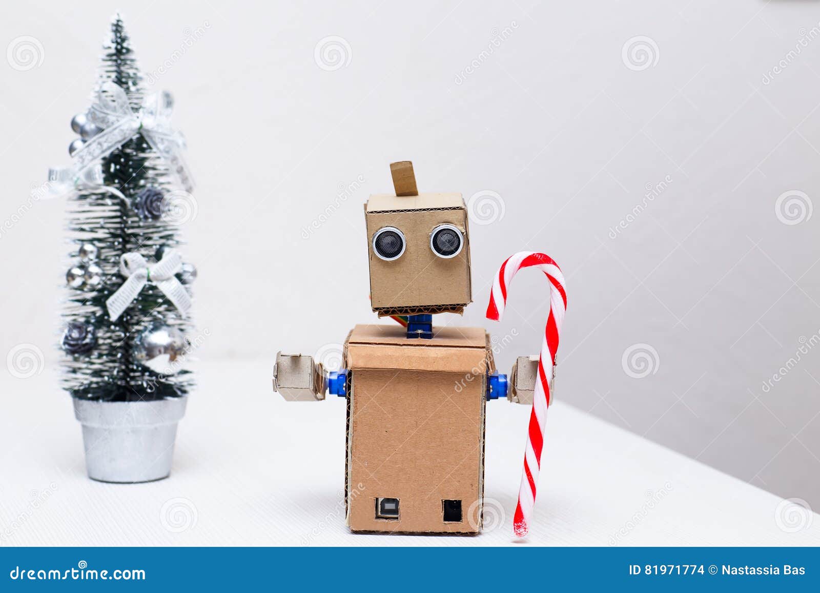 Robot with Arms and Christmas Decorations on the Table Stock Photo ...