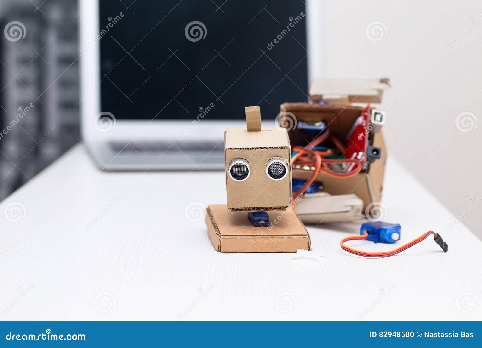 Robot in the Assembly Process on a White Table Home Stock Photo - Image ...