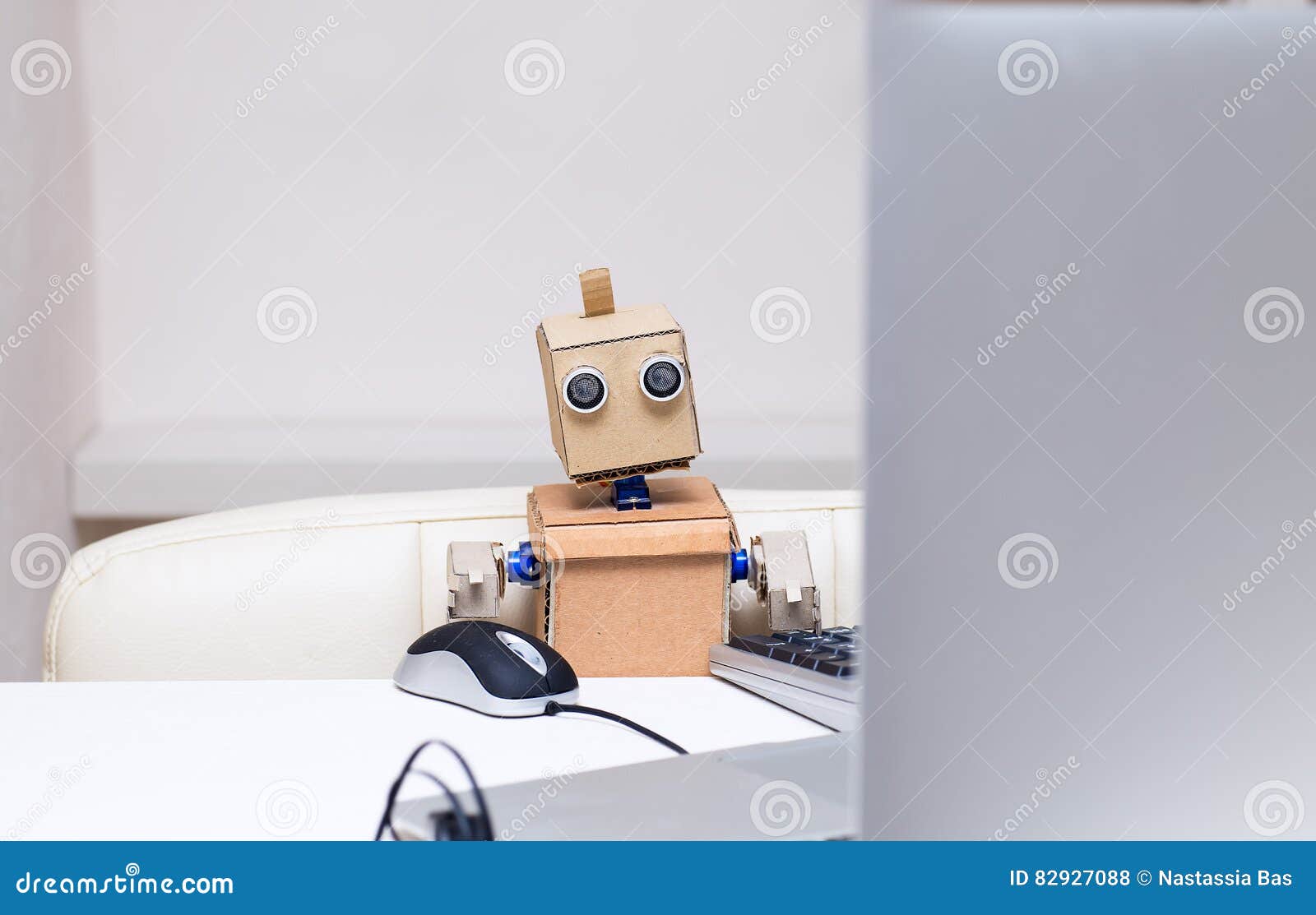 The Robot is Busy Working on the Computer at the Table Stock Photo ...