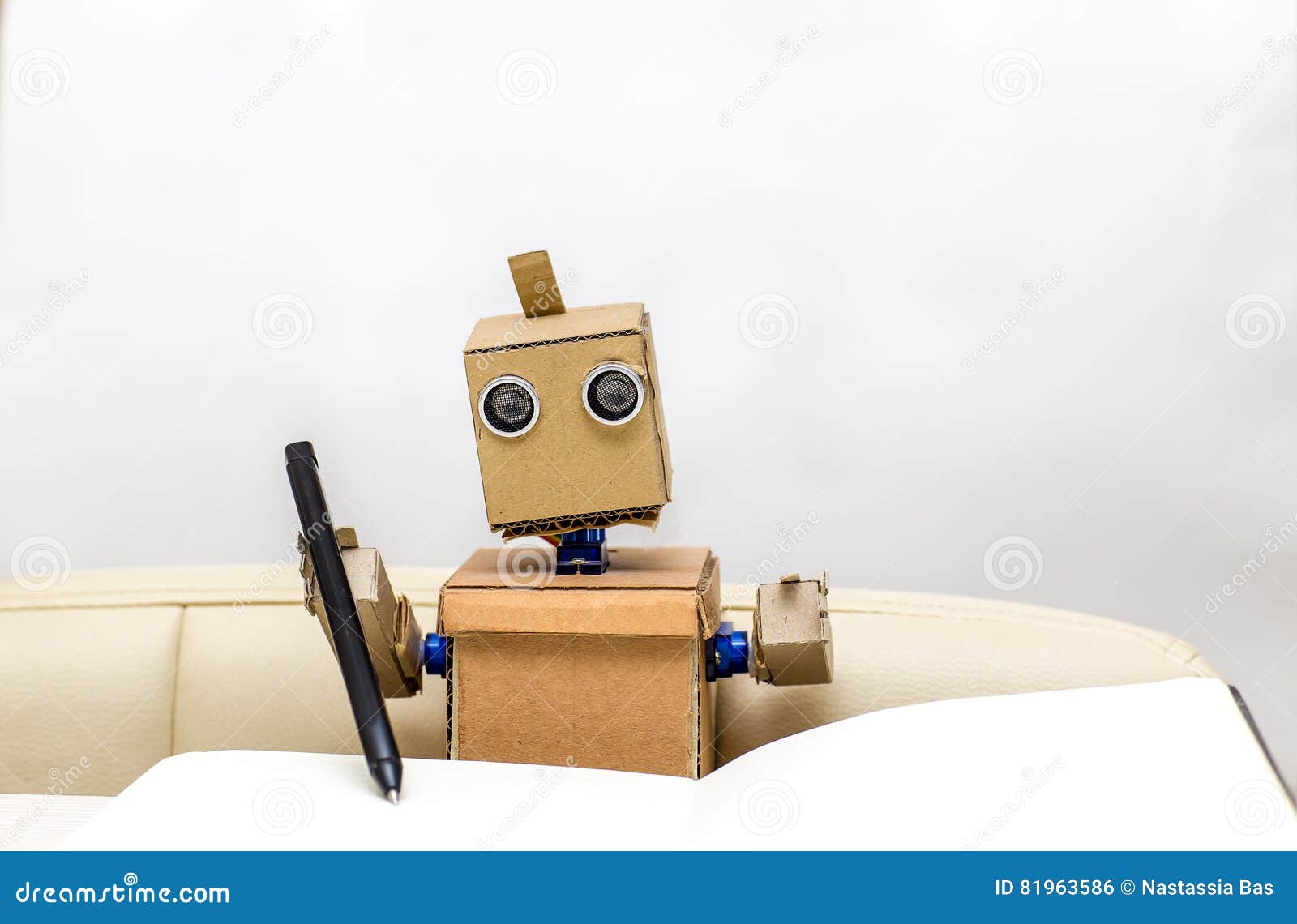 Robot Holds in His Hands a Pen Stock Photo - Image of fantasy, robot ...
