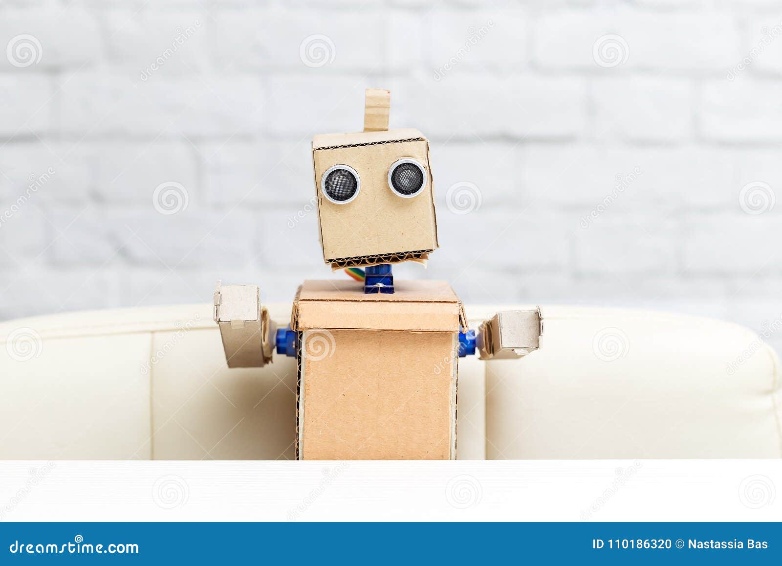The Robot Sits at the Table. Portrait of a Robot Stock Photo - Image of ...
