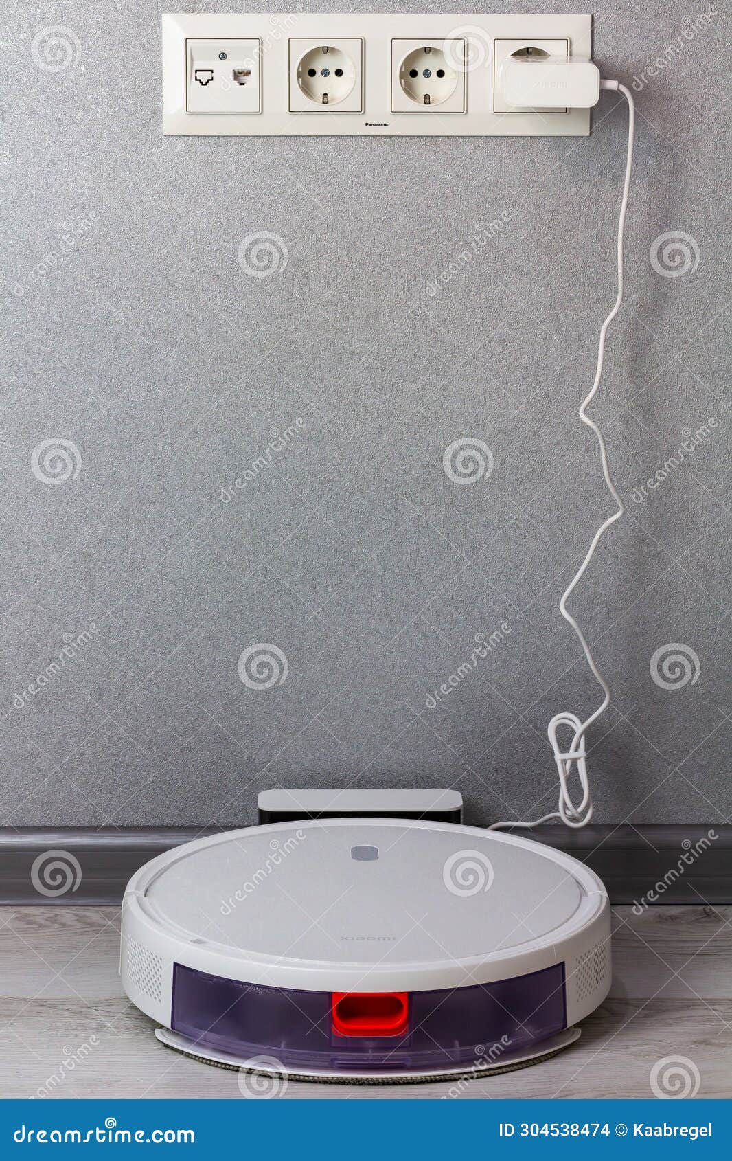 Robot Vacuum Cleaner on a Charging Station. Smart Technology Controlled ...