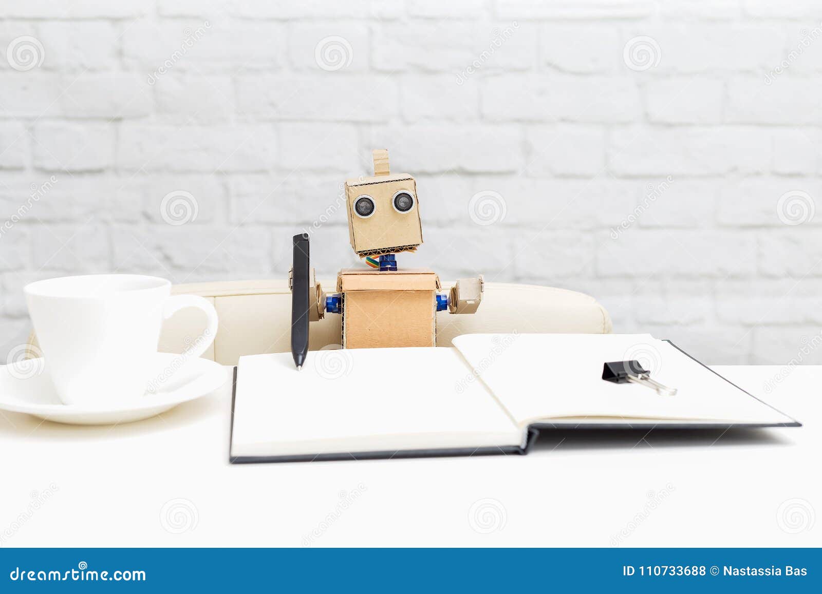The Robot Writes in the Notebook with a Pen. Artificial Intelligence ...