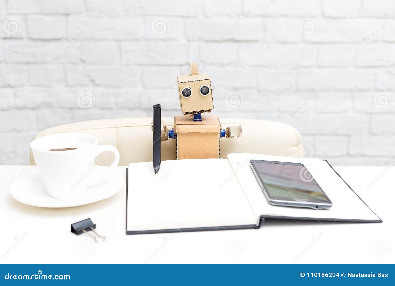 The Robot Writes with a Pen in the Notebook. Stock Photo - Image of ...