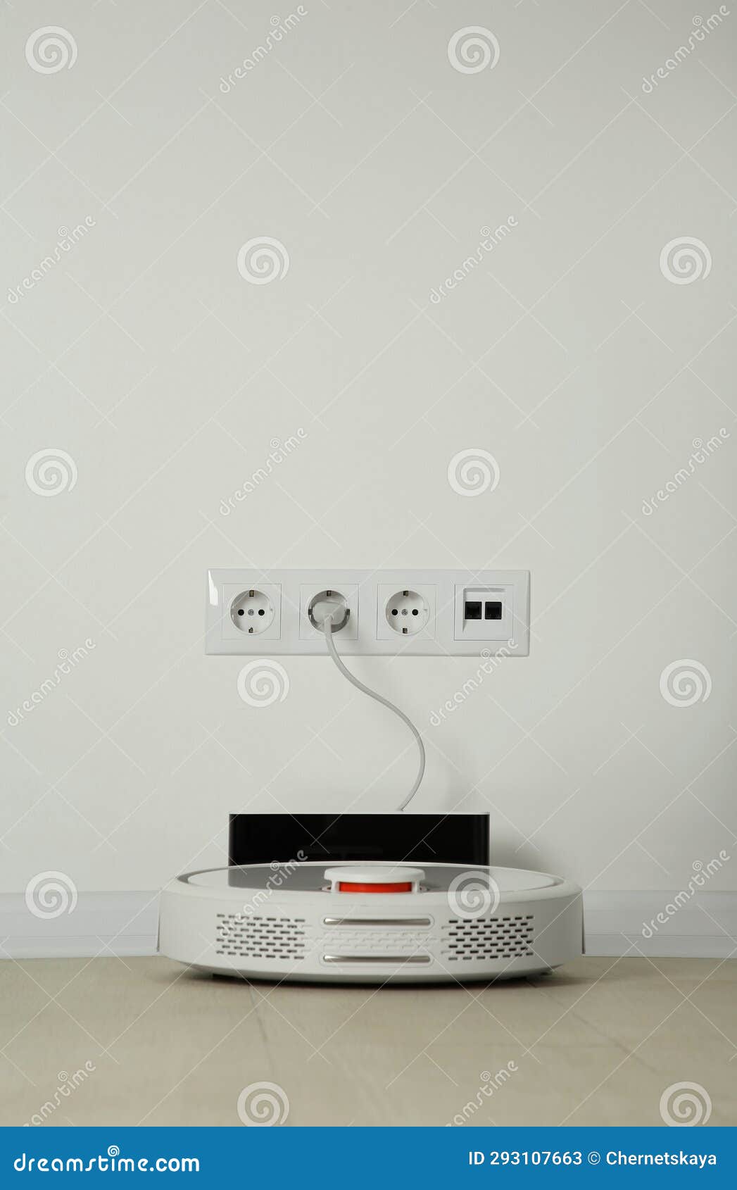Robotic Vacuum Cleaner Charging from Electric Socket on Floor Indoors ...