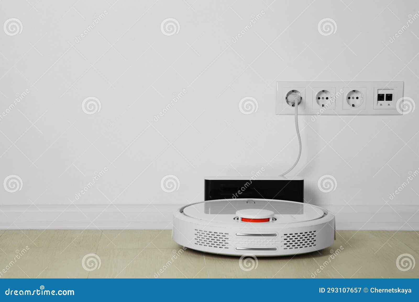 Robotic Vacuum Cleaner Charging from Electric Socket on Floor Indoors ...