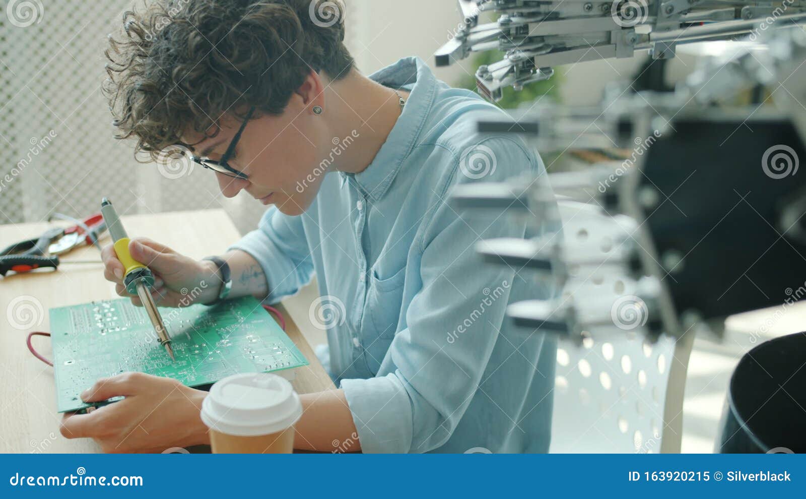Robotics Engineer Making Robot Microcircuit with Soldering Iron in ...