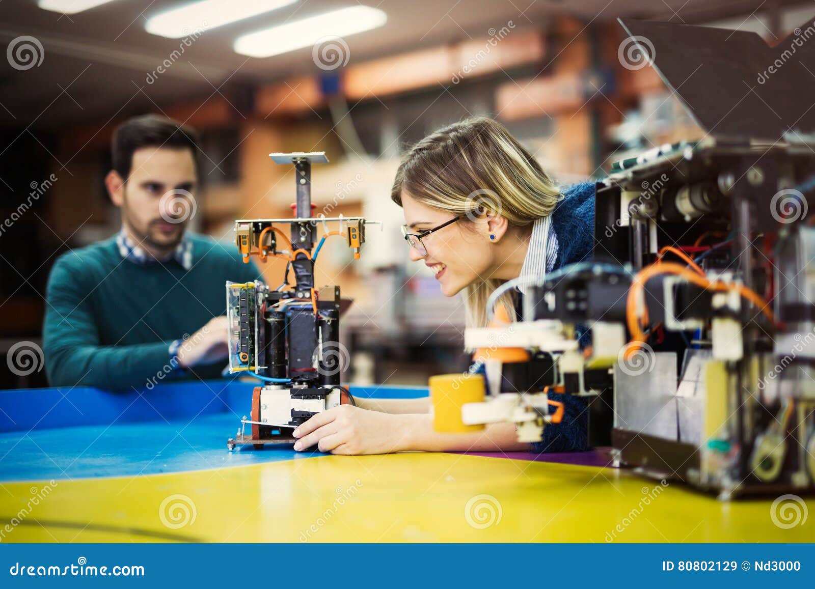 Robotics Engineer Working On Desing Of Modern Robotic Arm And Sitting ...