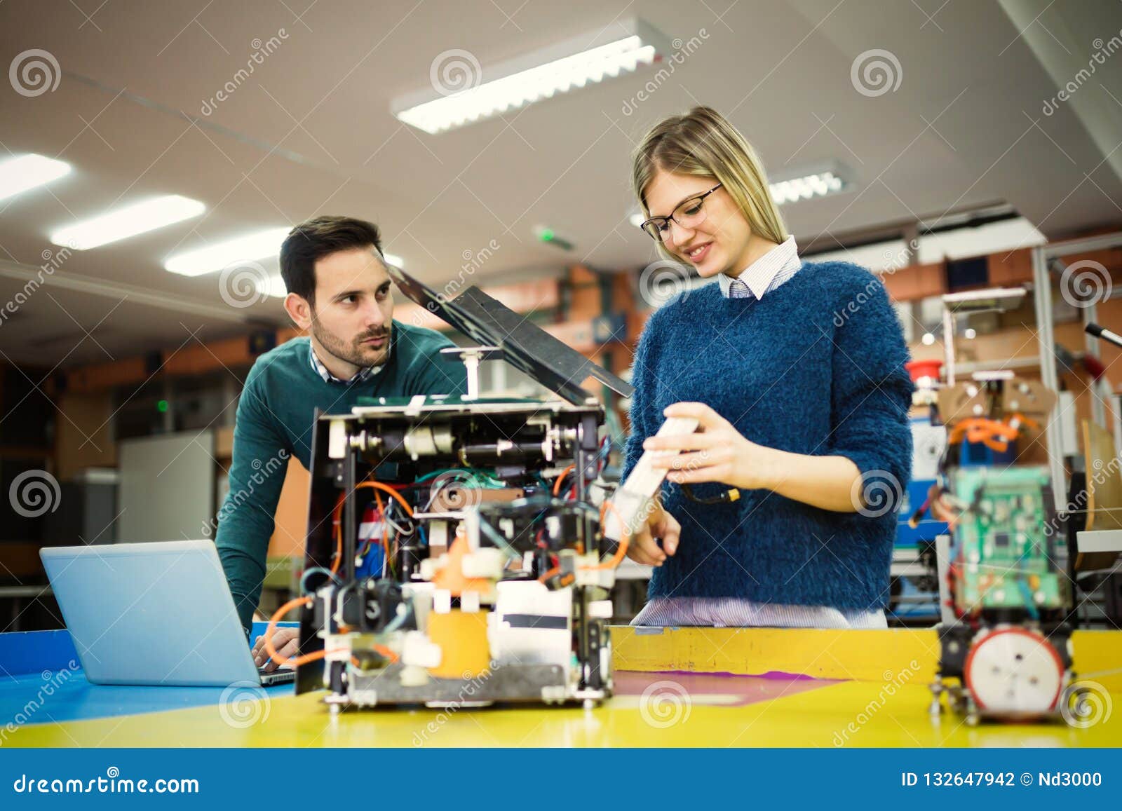 Robotics Engineer Working On Desing Of Modern Robotic Arm And Sitting ...