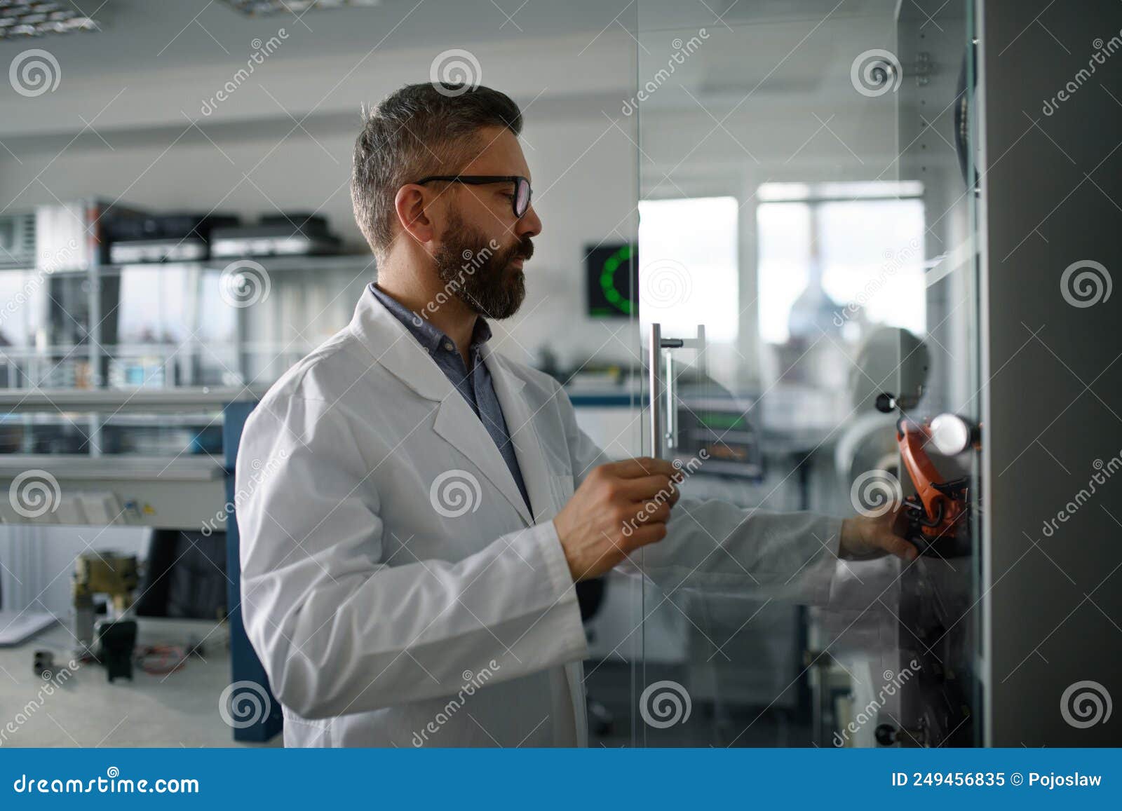 Robotics Engineer Working on Desing of Modern Robotic Arm in Laboratory ...
