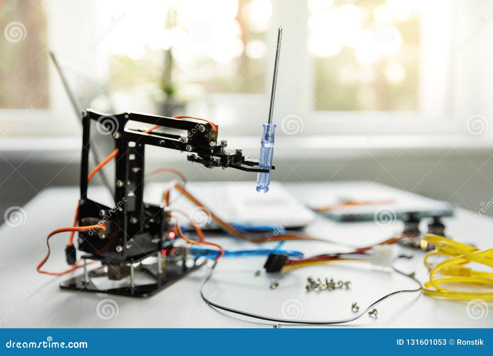 Robotics Industry - Robot Arm and Laptop on the Table Stock Image ...